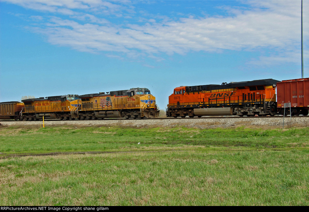 BNSF 6979 Dpu shoves past a Sb up coal train.